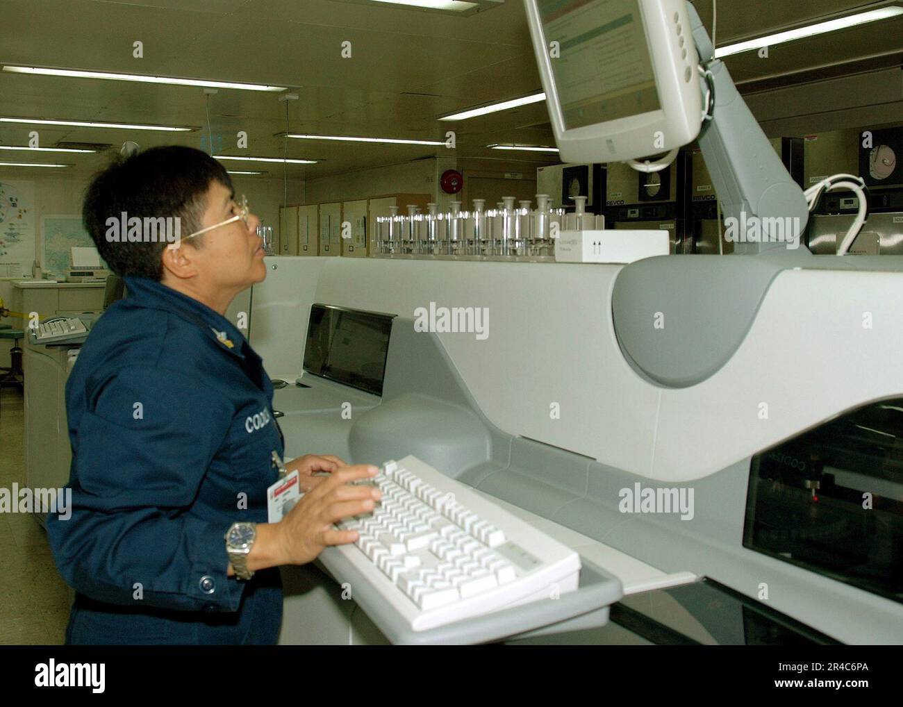 US Navy Hospital Corpsman 1st Class runs a chemistry test on blood in ...