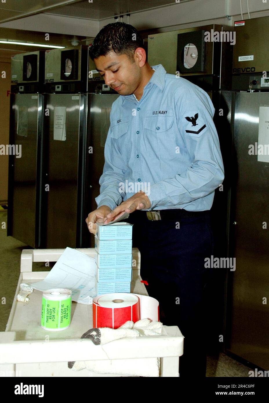 US Navy Hospital Corpsman 3rd Class organizes boxes of agents that are ...