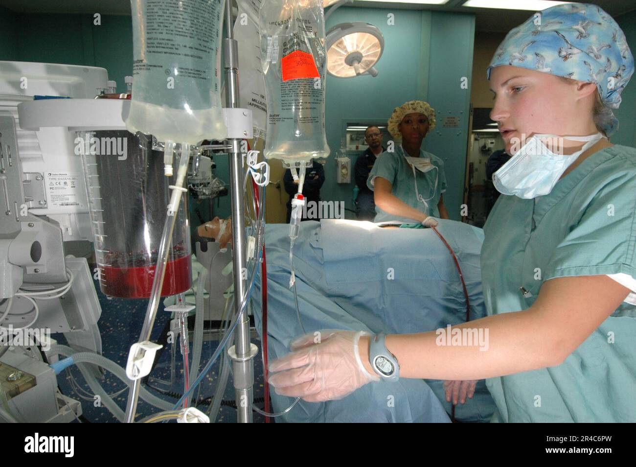 US Navy Hospital Corpsman checks the flow of blood through a cell saver ...