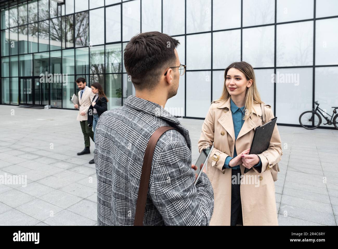 Group of business people discussing ideas at meeting outside ...