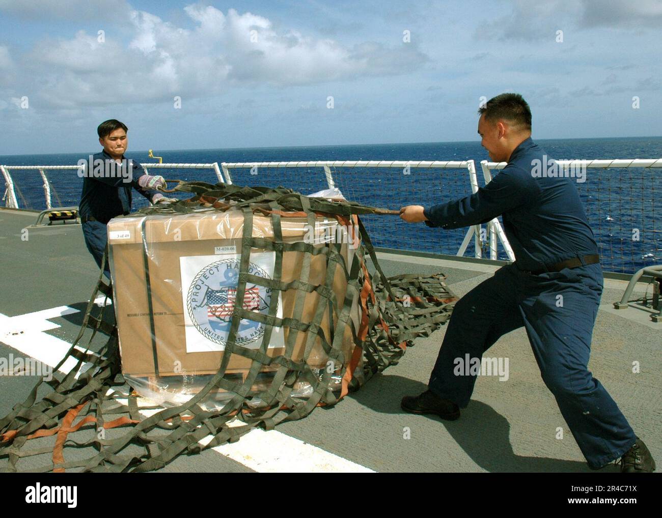 US Navy Two Sailors prepare boxes to be air lifted in support of ...