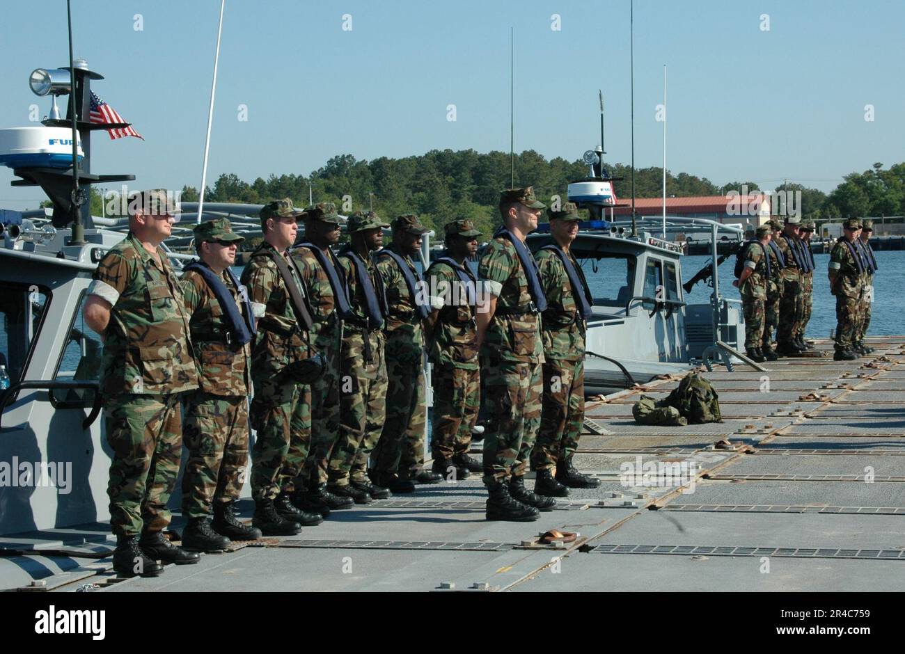 US Navy Navy Coastal Warfare Squadron Four (NCWS-4) Sailors stand at ...