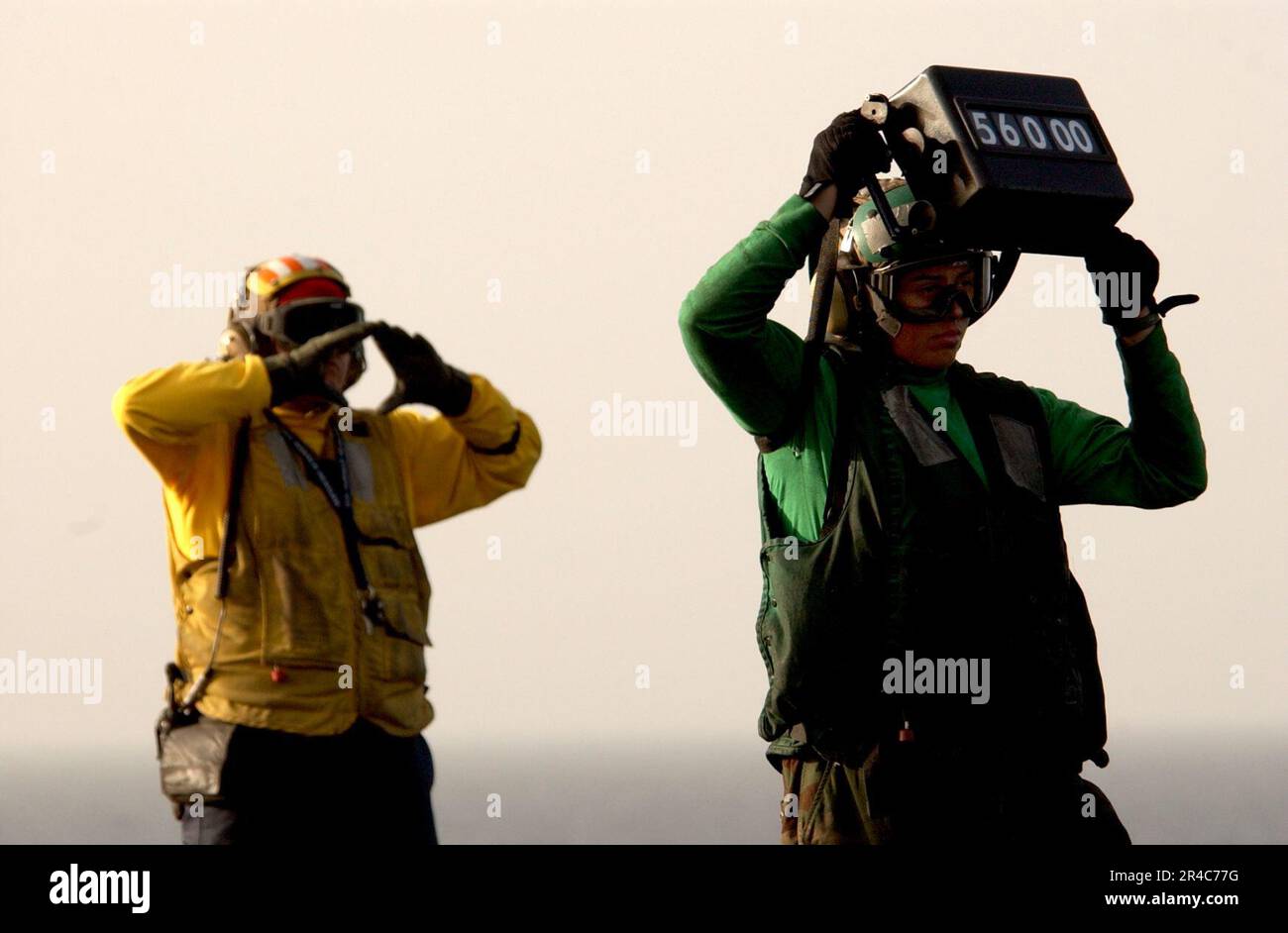 US Navy A weight-board operator verifies the gross weight of an ...