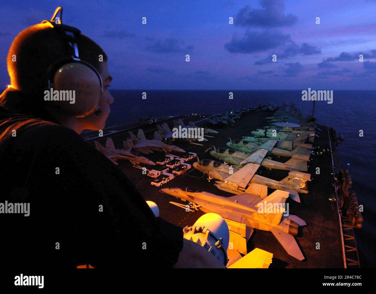 US Navy Operations Specialist Seaman stands watch on the signal bridge ...