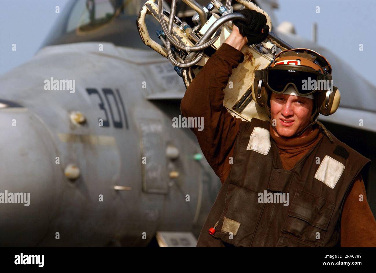 US Navy After servicing the engines of an F-A-18C Hornet, plane captain ...