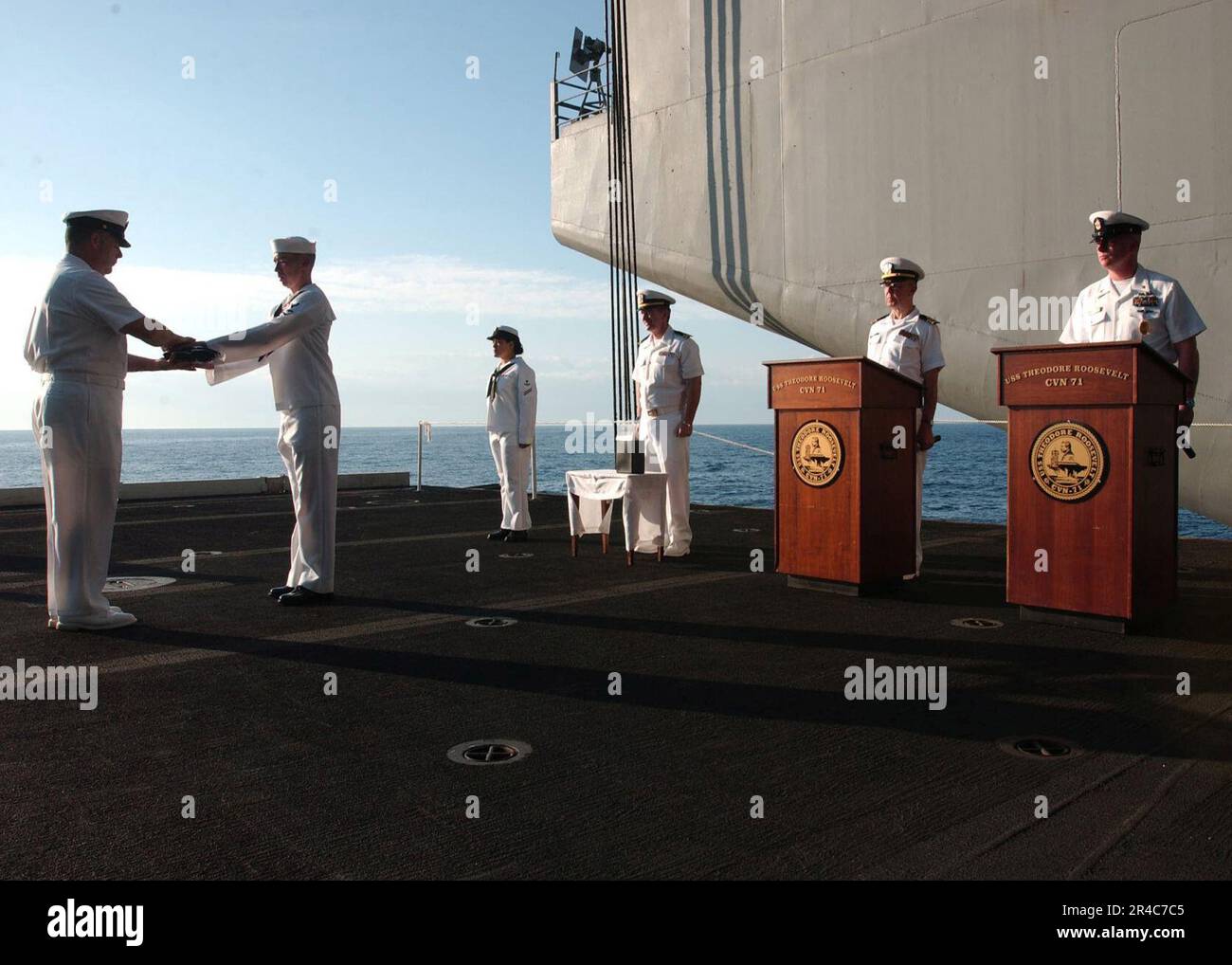 US Navy Command Master Chief accepts the ceremonial flag during a ...