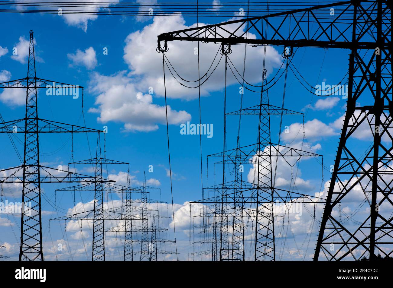 high voltage electric pylons against sky with dramatic clouds Stock ...