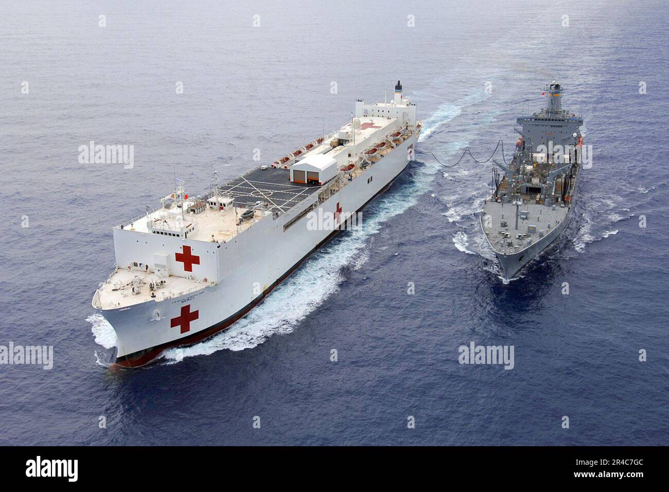 US Navy USNS Mercy performs an underway replenishment operation with ...