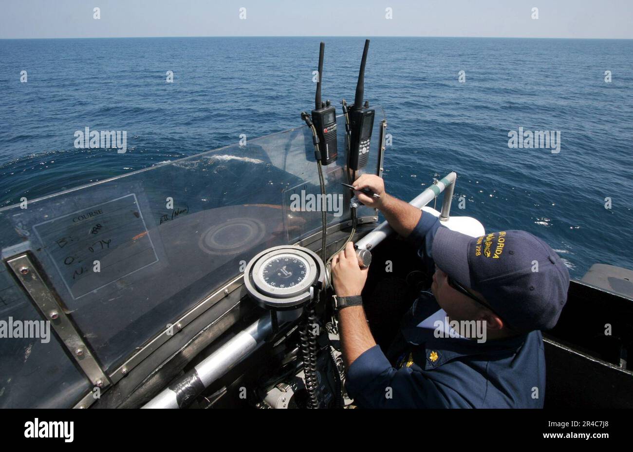 US Navy Lt. Cmdr. stands Officer of the Deck watch from the bridge of ...