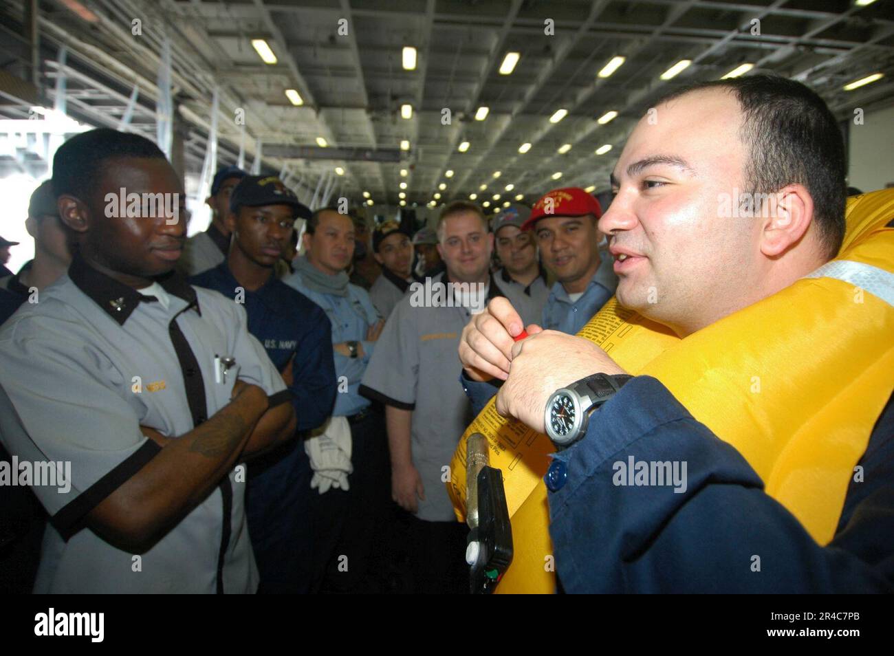US Navy Culinary Specialist Seaman conducts training on the use of an ...