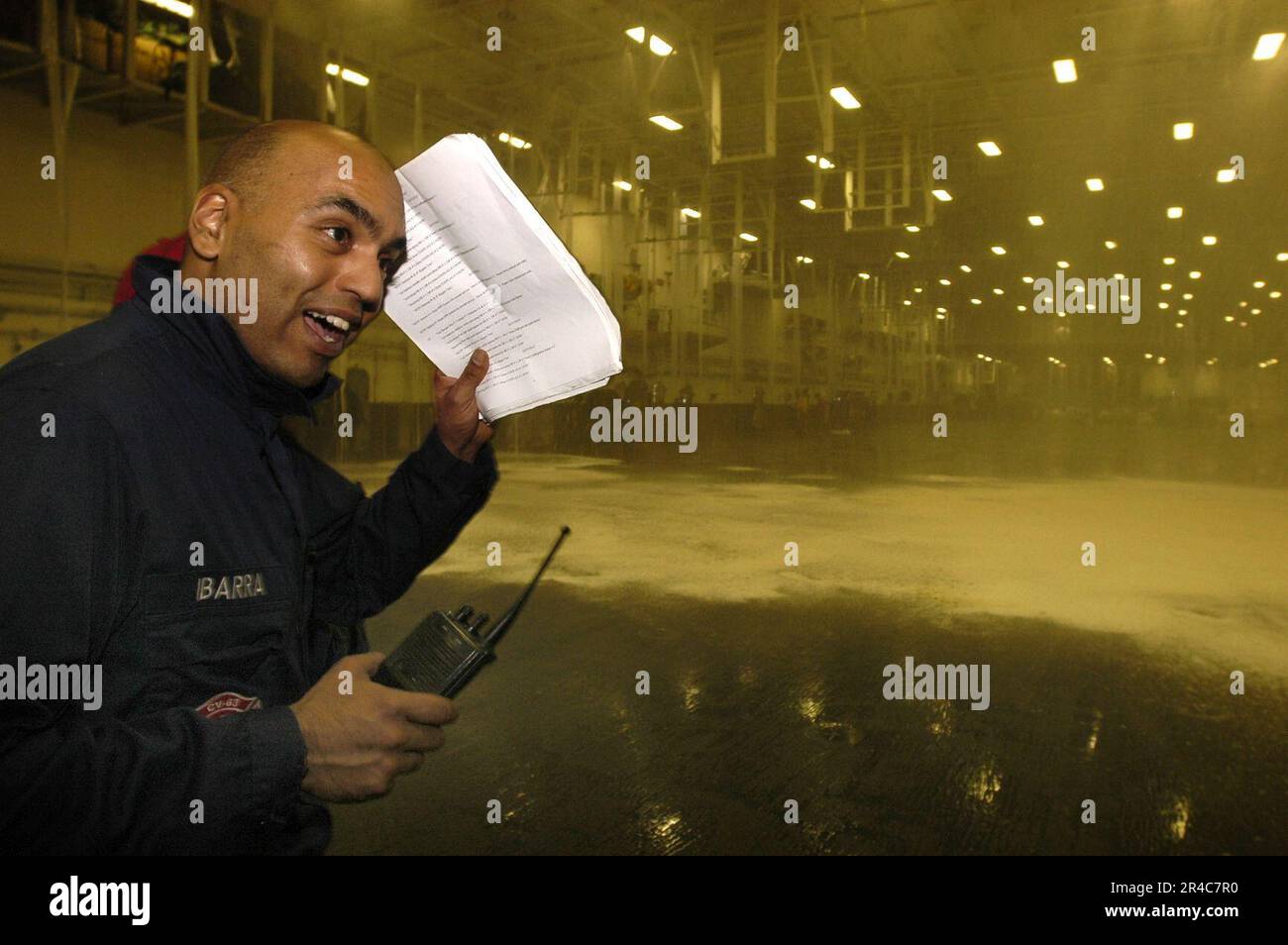 US Navy Damage Controlman 1st Class coordinates the light-off of the ...