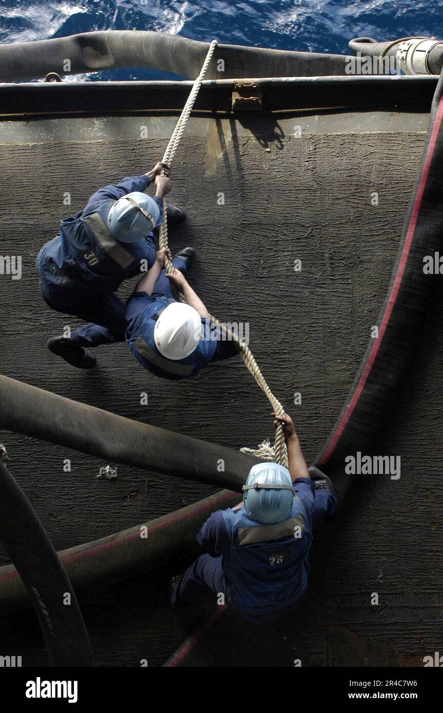 US Navy Deck department personnel set up a close-in fuel rig while ...