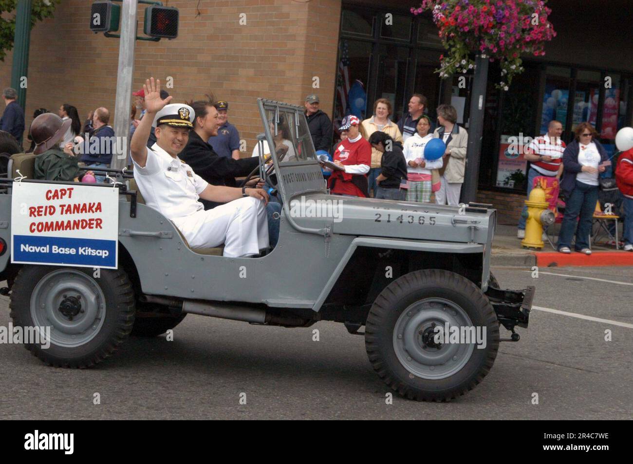 US Navy Commanding Officer, Naval Base Kitsap Capt. waves to the crowd ...