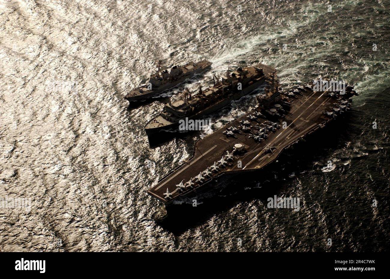 US Navy USNS Rainier (T-AOE 7), center, is met by the Nimitz-class ...