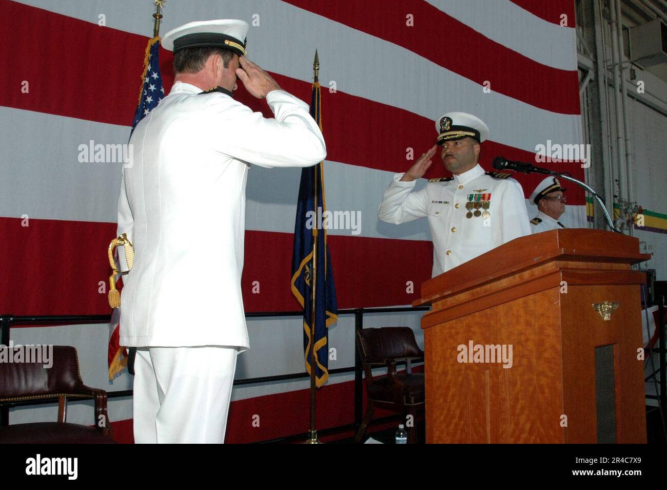 US Navy Cmdr. salutes Cmdr. during a change of command ceremony held ...