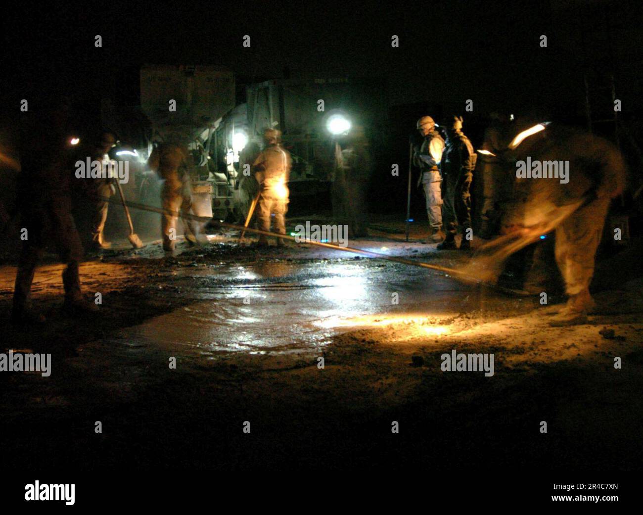 US Navy Seabees pour concrete on a road repair project in Fallujah ...