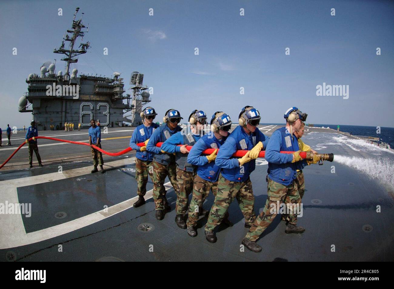 US Navy Air department personnel wash Aqueous Film Forming Foam (AFFF ...