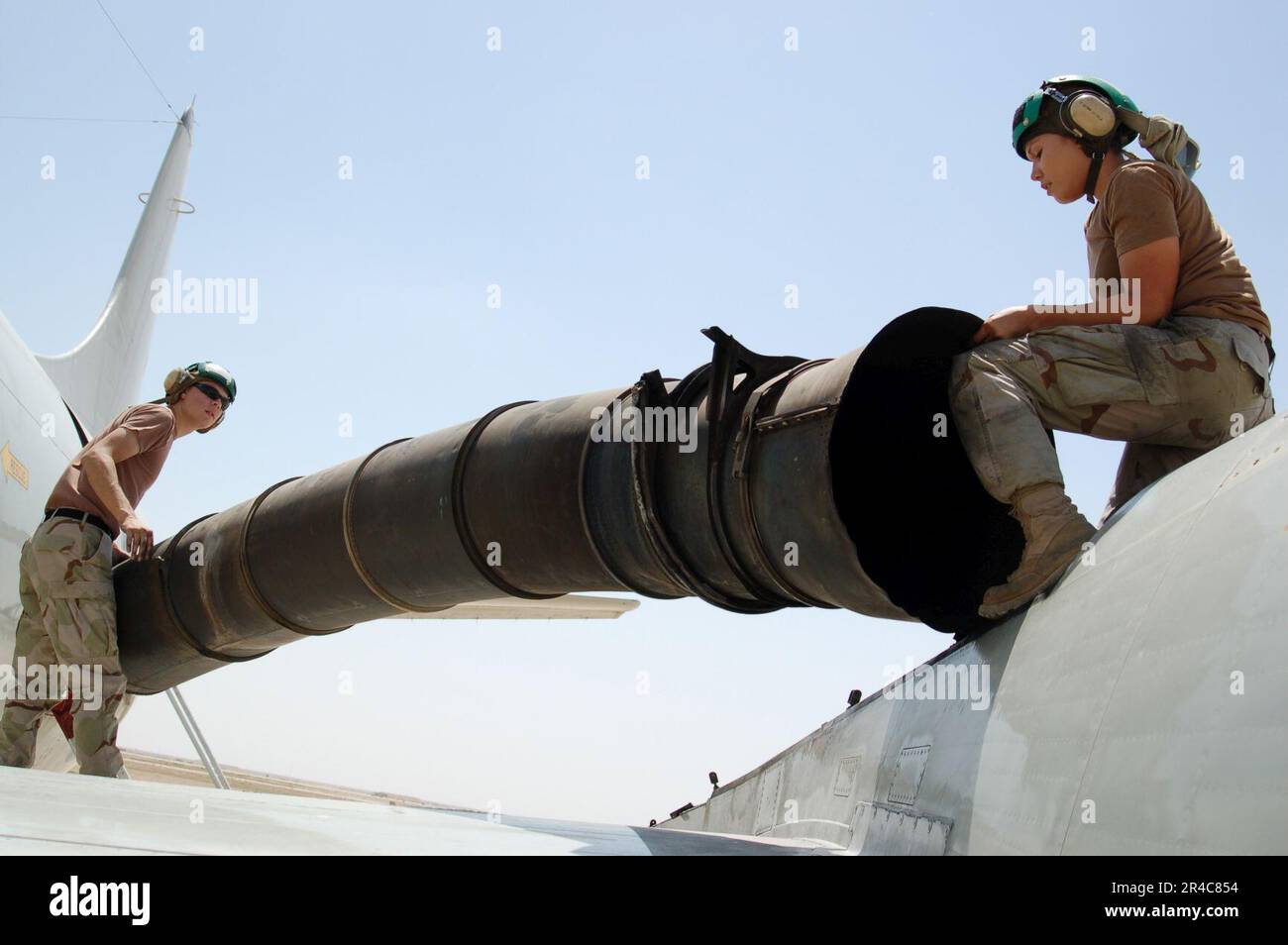 US Navy Aviation Machinist's Mate 2nd Class right, assist a another ...