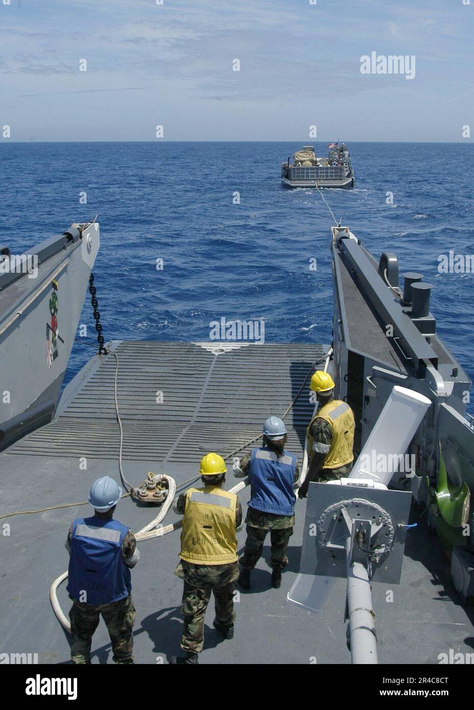 US Navy Deck Seamen aboard Landing Craft Utility (LCU) 1648 give slack ...