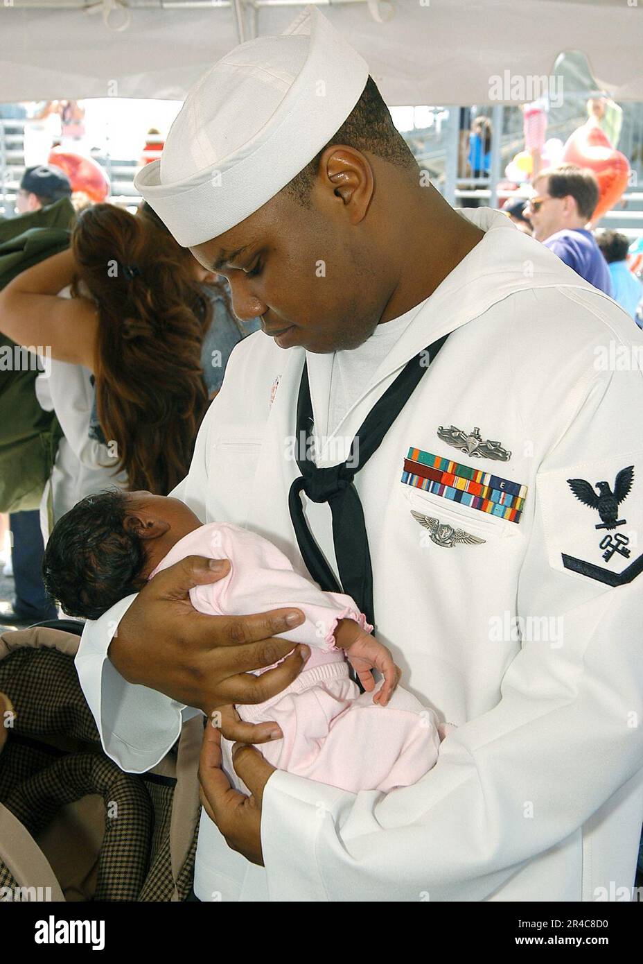US Navy Storekeeper 3rd Class holds his baby for the first time after ...