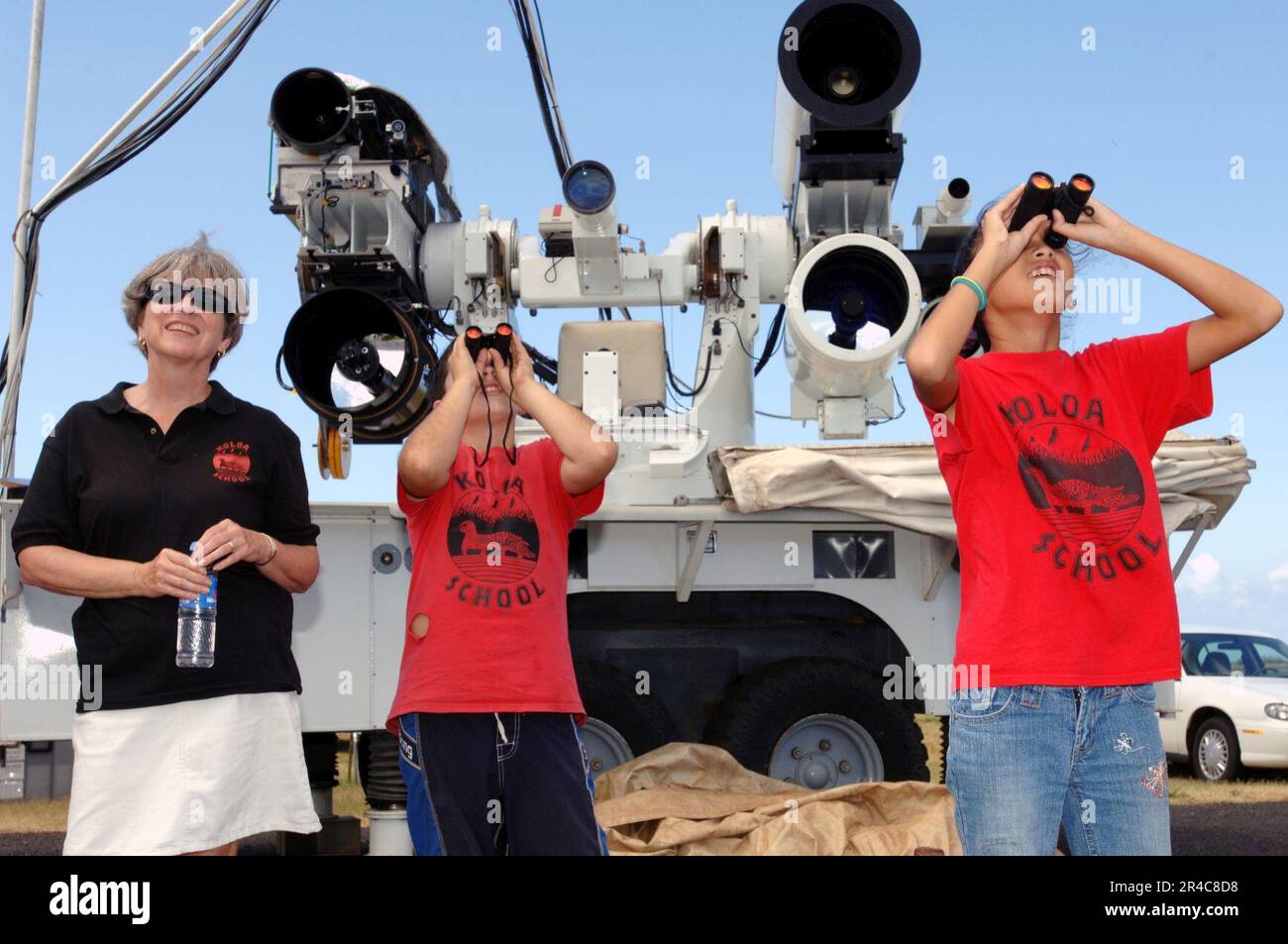 US Navy Koloa School math teacher left, scans the sky with fifth grade ...