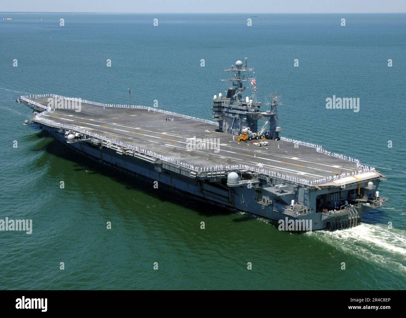 US Navy Sailors man the rail aboard the Nimitz-class aircraft carrier ...
