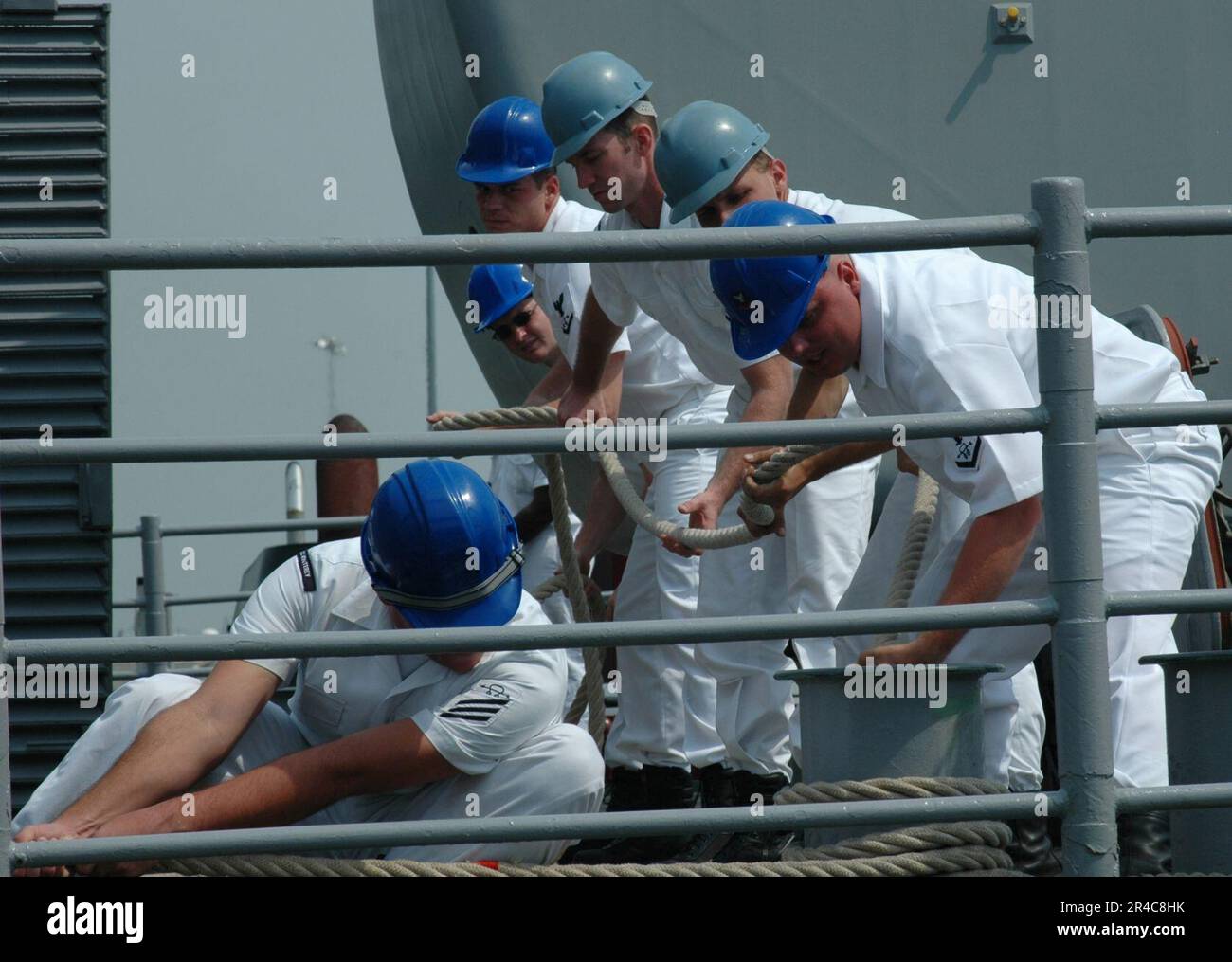 US Navy Line handlers aboard the guided-missile cruiser USS Monterey ...