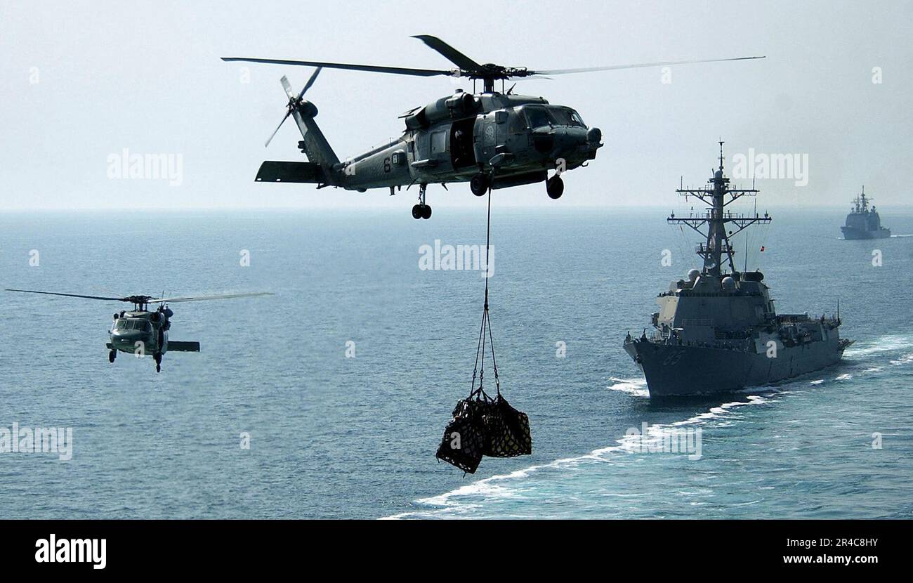 US Navy Two MH-60S Knighthawks conduct a vertical replenishment ...