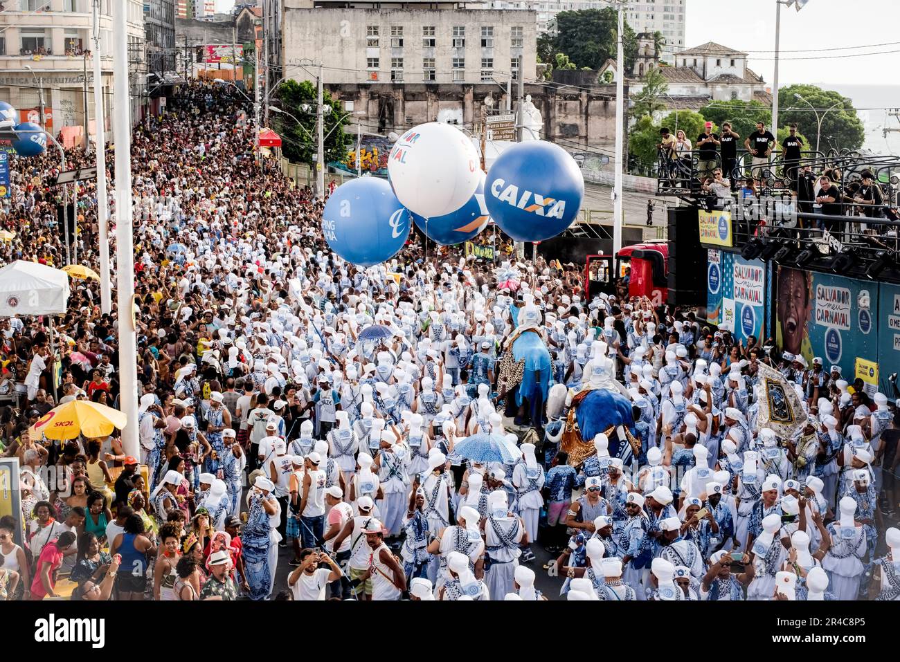 A diverse group of people joyfully marching in a parade, with blue ...