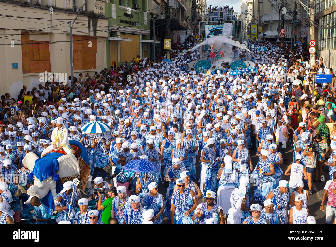 A diverse group of people joyfully marching in a parade, with blue ...