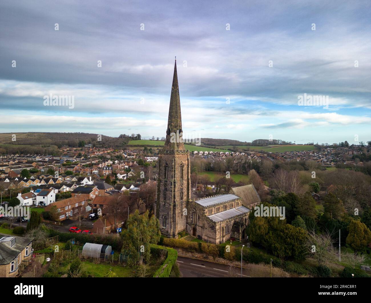 A picturesque view of an old church with a steepled roof, surrounded by ...