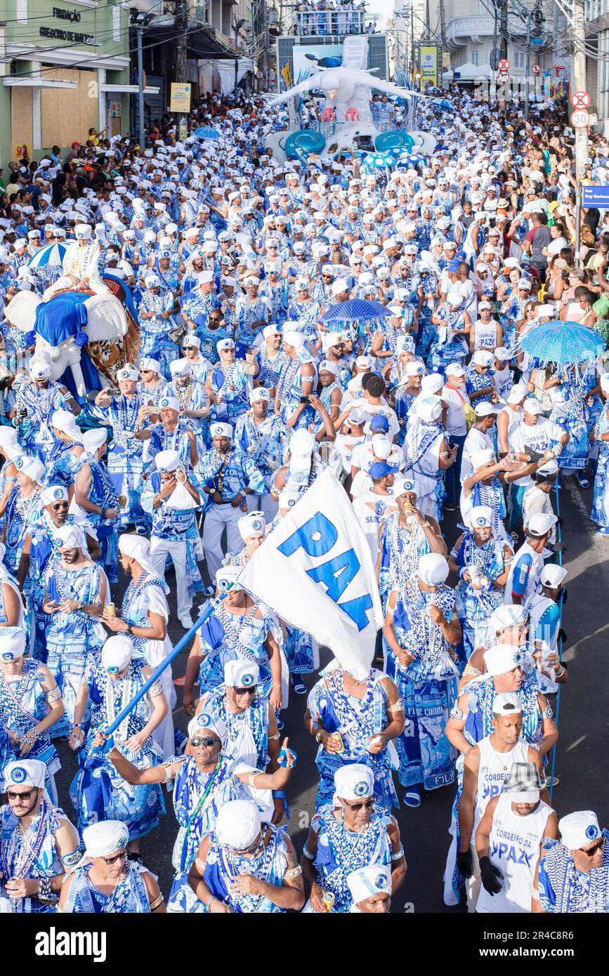 A diverse group of people joyfully marching in a parade, with blue ...