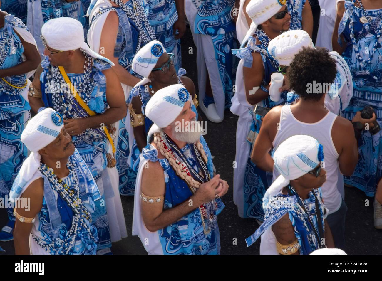 A diverse group of people joyfully marching in a parade, with blue ...