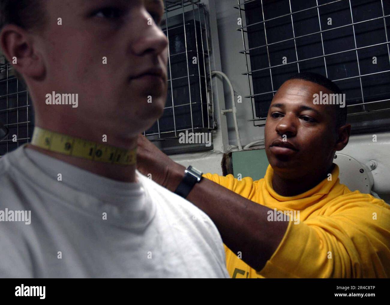 US Navy Chief Aviation Boatswain's Mate Handler checks neck measurement ...