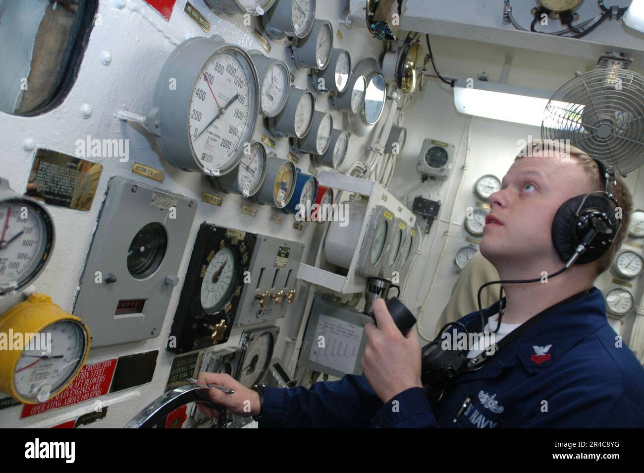 US Navy Machinist's Mate 1st Class performs throttleman duties in USS ...