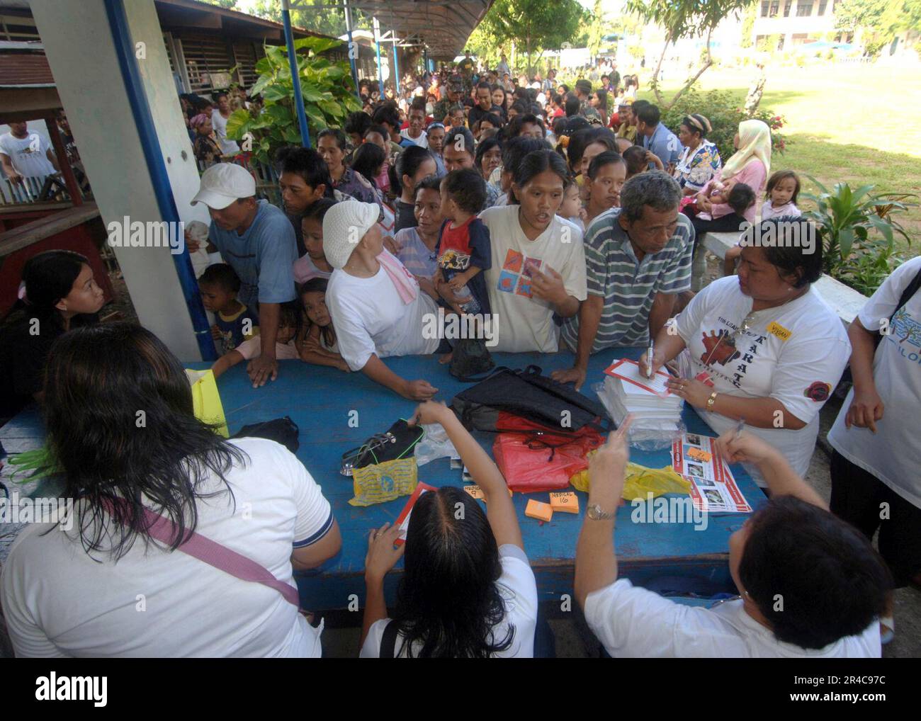 US Navy Patients line up by the thousands to register for medical and ...