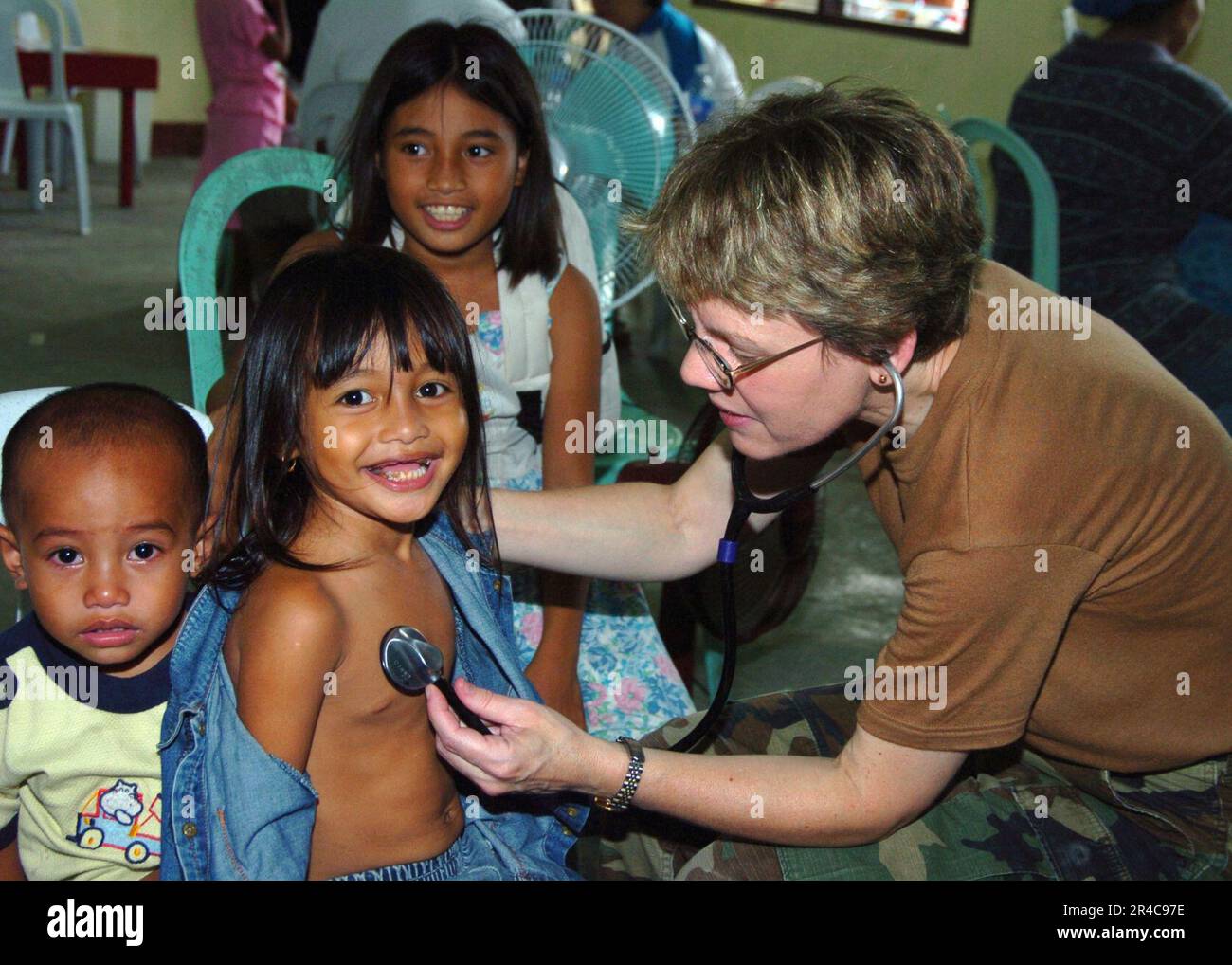US Navy U.S. Air Force Major evaluates a child as part of a medical ...