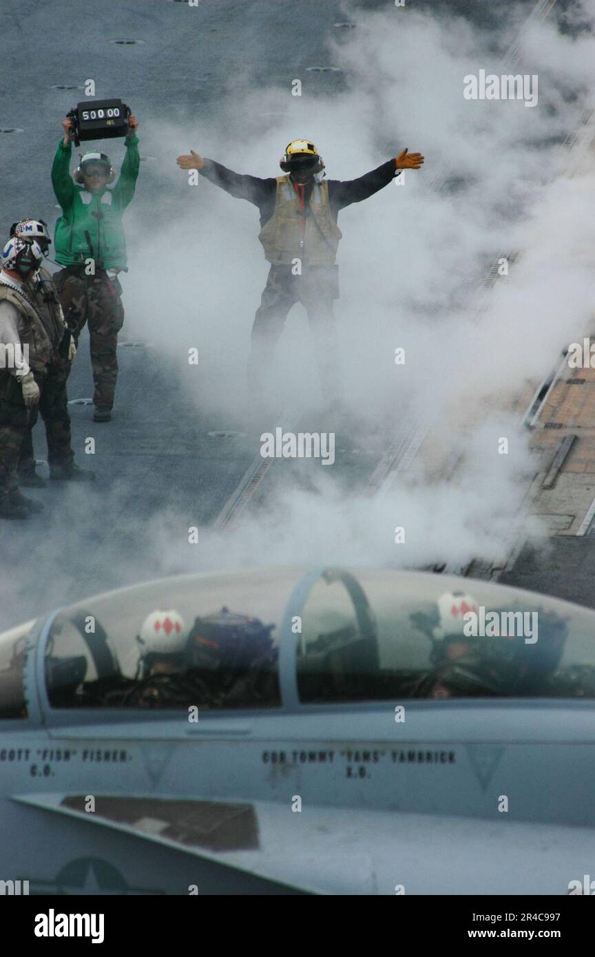 US Navy An aircraft director guides an F-A-18F Super Hornet from the ...