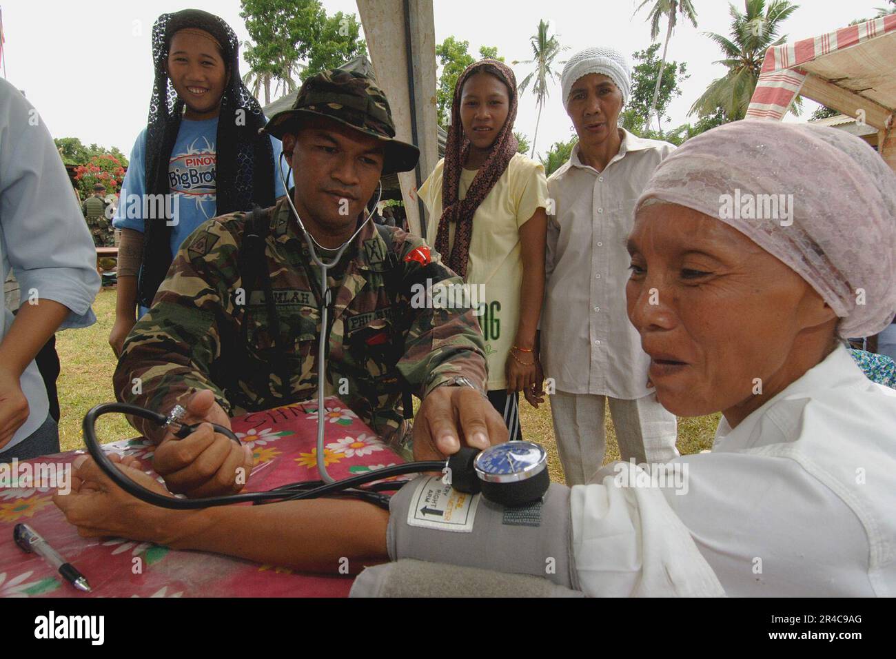 US Navy A member of the Philippine Army checks vital signs of a local ...