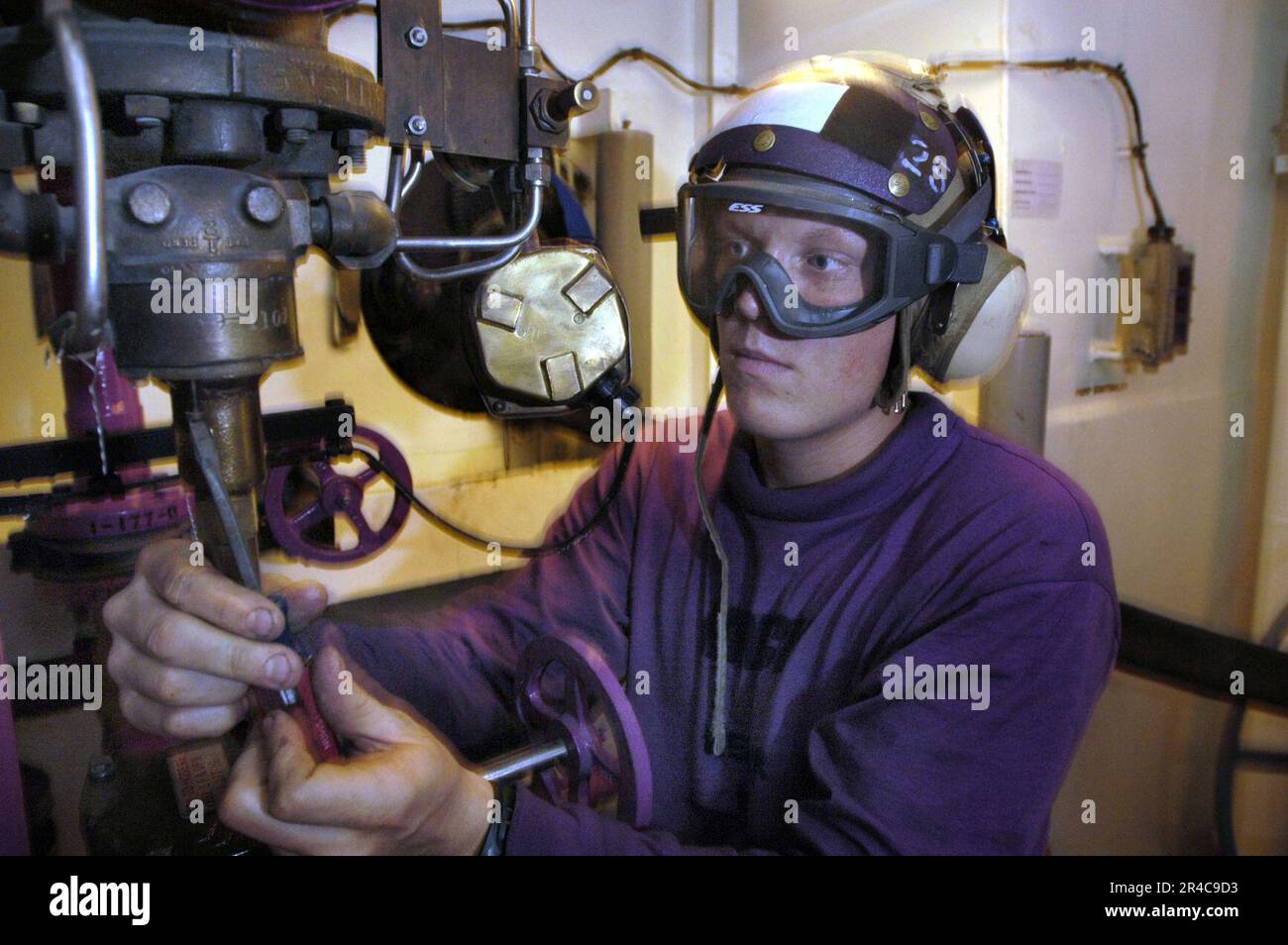 US Navy Aviation Boatswain's Mate (Fuels) Airman changes the diaphragm ...