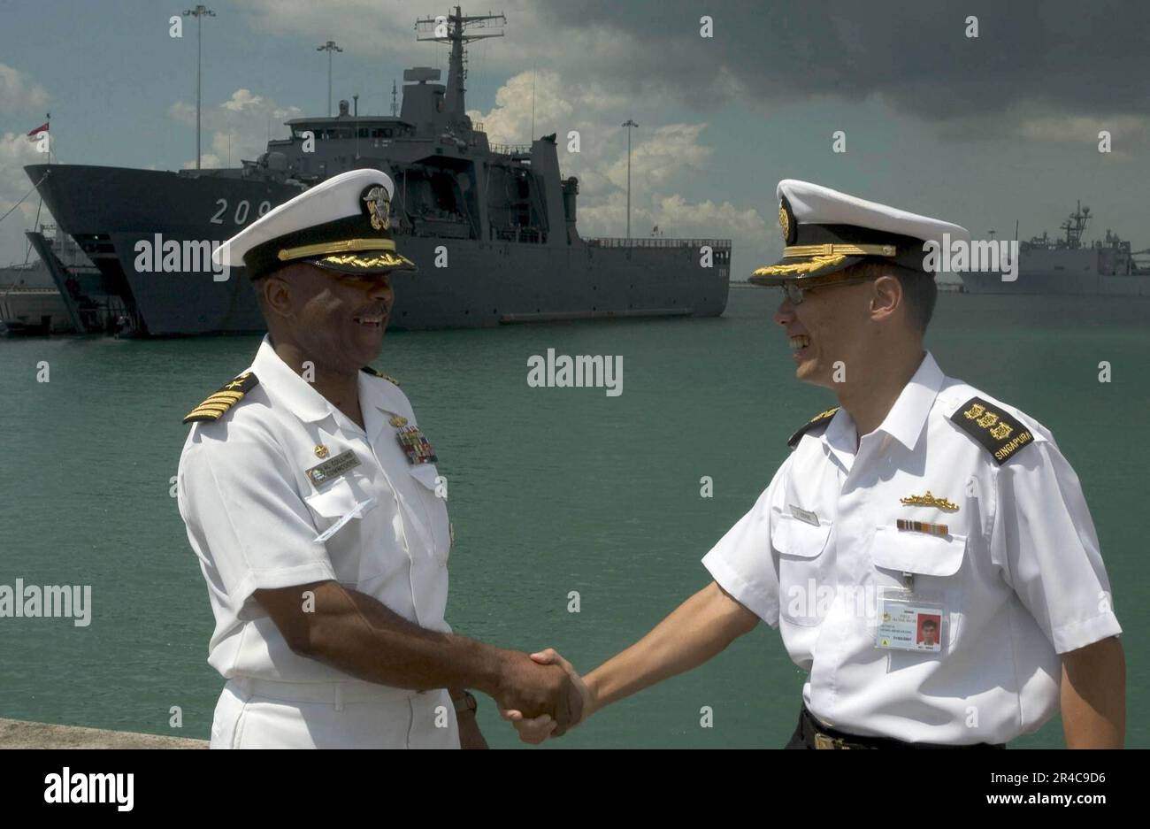 US Navy Commander, Destroyer Squadron One, Capt. shake hands with Col ...