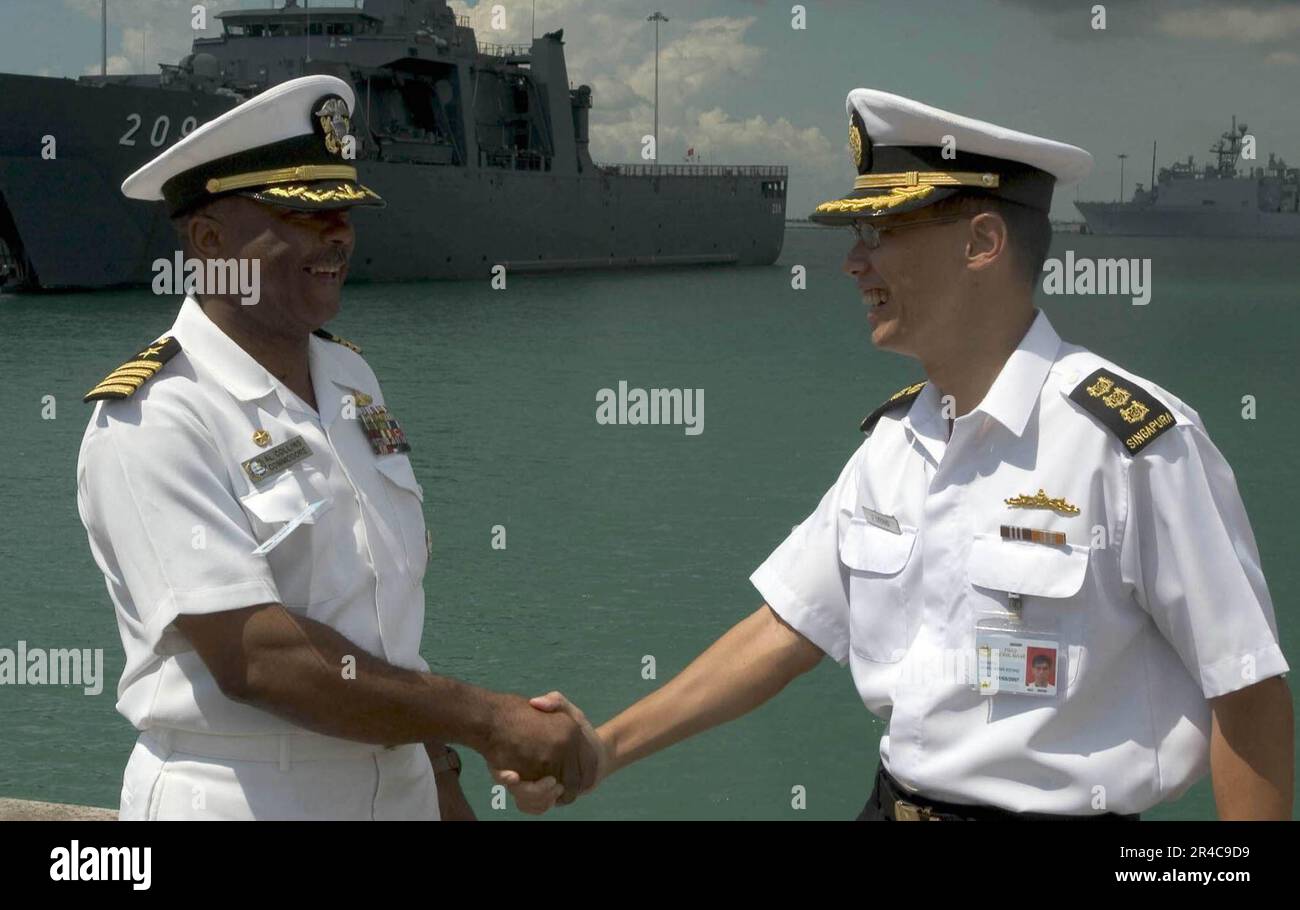 US Navy Commander, Destroyer Squadron One, Capt. shake hands with Col ...