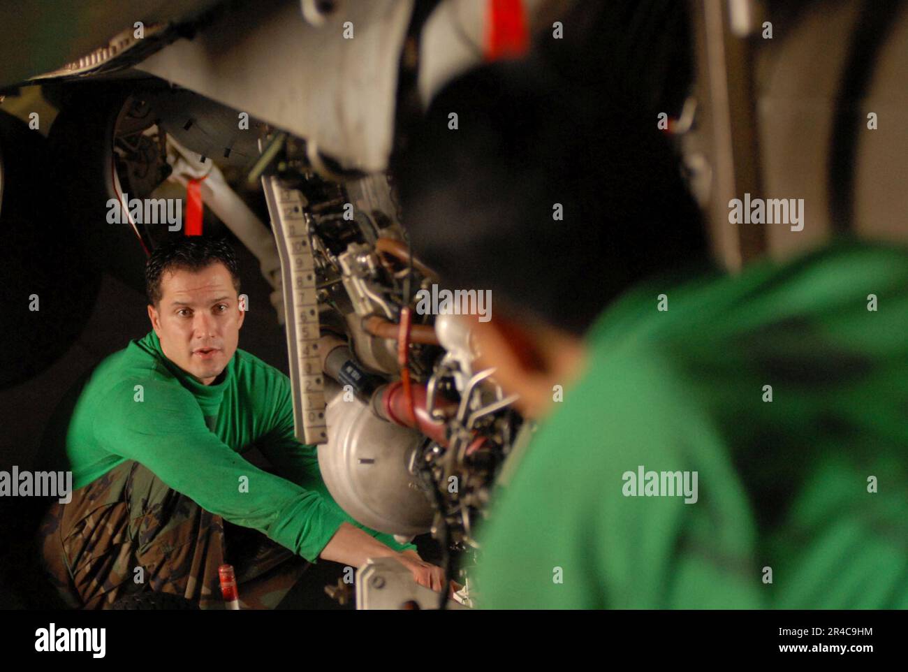US Navy Aviation Machinist's Mate 1st Class replaces the jet engine of ...