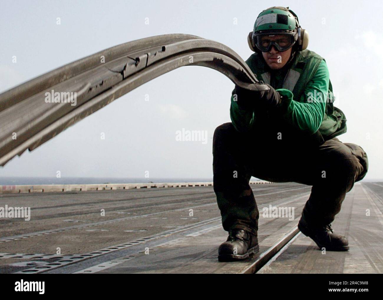 US Navy Aviation Boatswain's Mate Equipment Airman wraps one of four ...