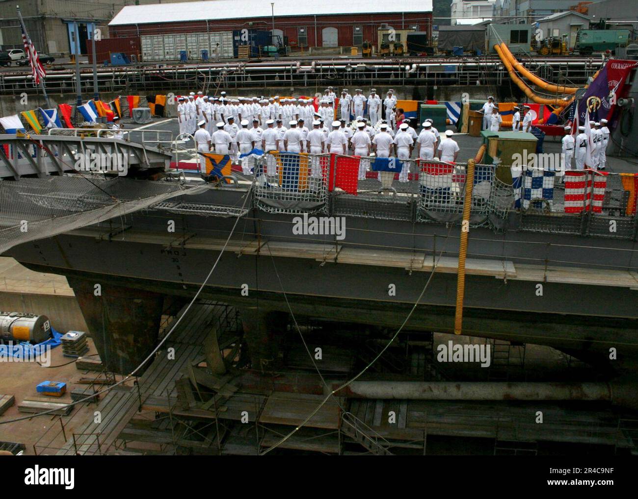 US Navy Crew members assigned aboard the Arleigh Burke-class guided ...