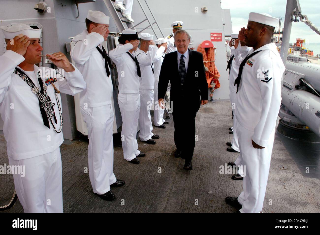 US Navy Secretary of Defense Donald H. Rumsfeld walks through the side ...