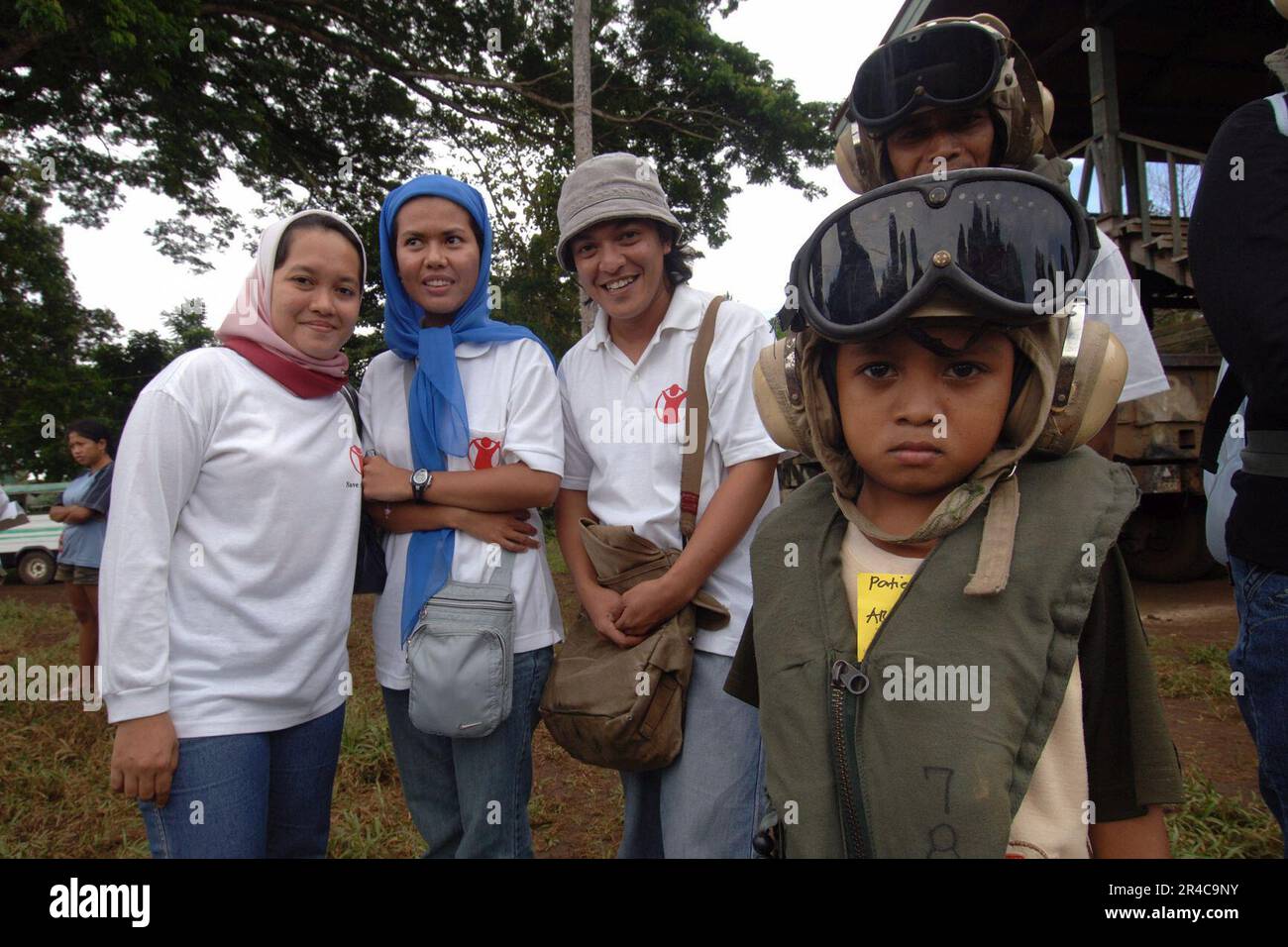 US Navy A Filipino boy's family gives him moral support as he shows signs of nervousness before ...