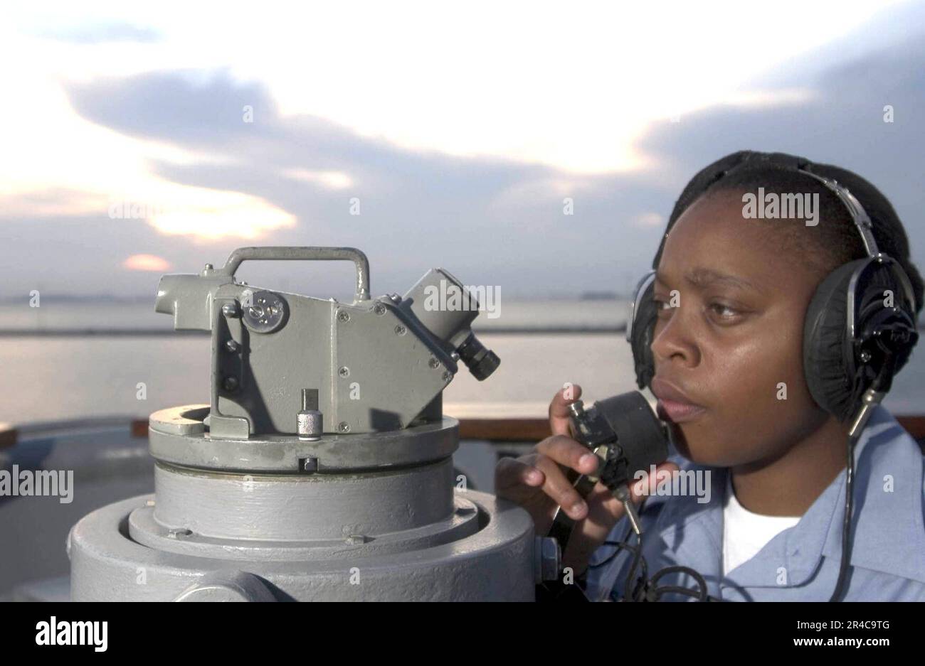 US Navy Quartermaster 3rd Class takes bearings from the portside bridge ...