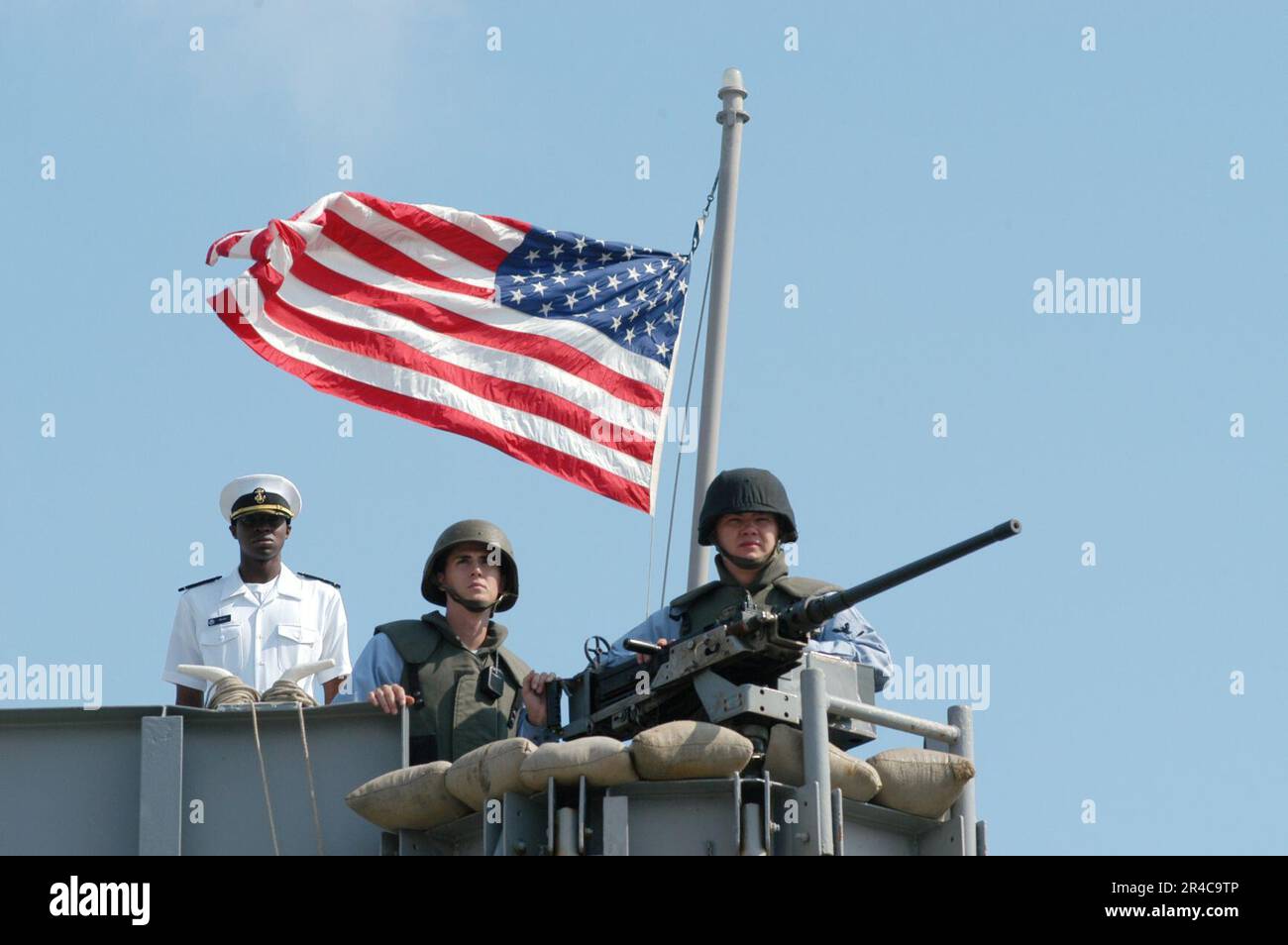 US Navy Sailors man a .50-caliber gun mount as the amphibious transport ...