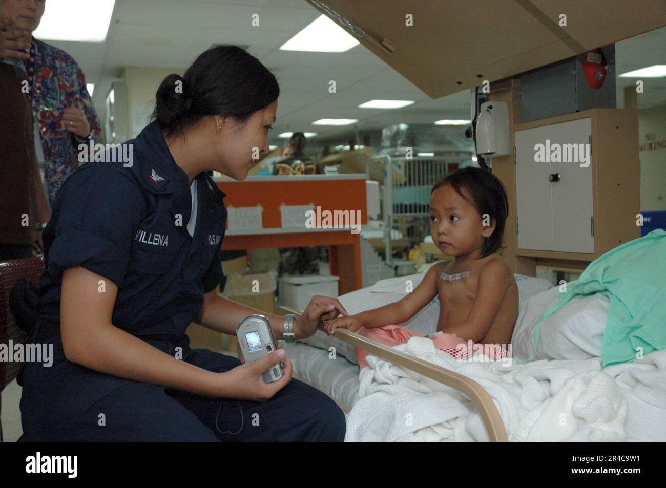 US Navy Navy Hospital Corpsman 3rd Class visits with a local pediatric ...